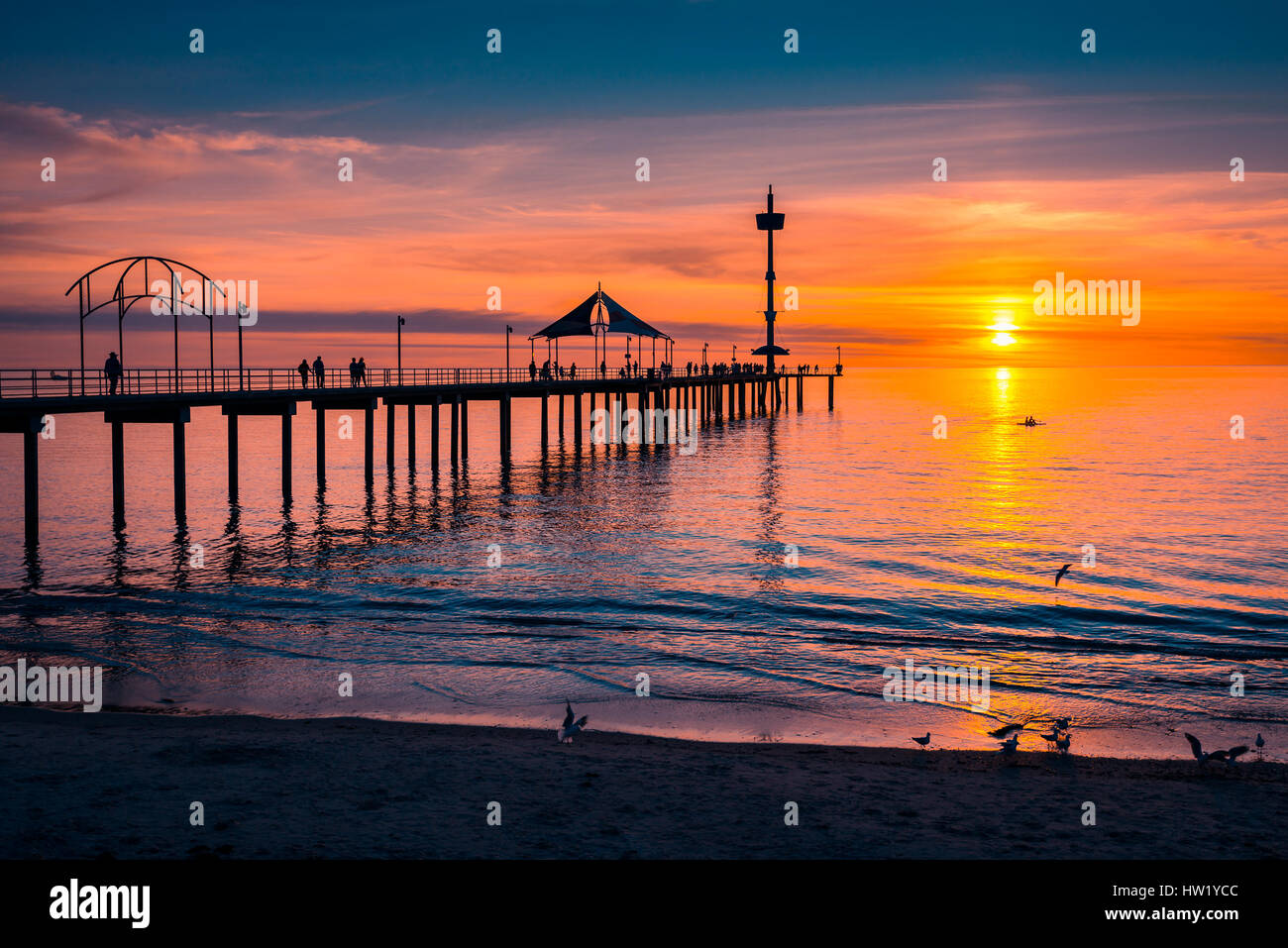 People walking on Brighton Jetty at sunset, South Australia Stock Photo ...