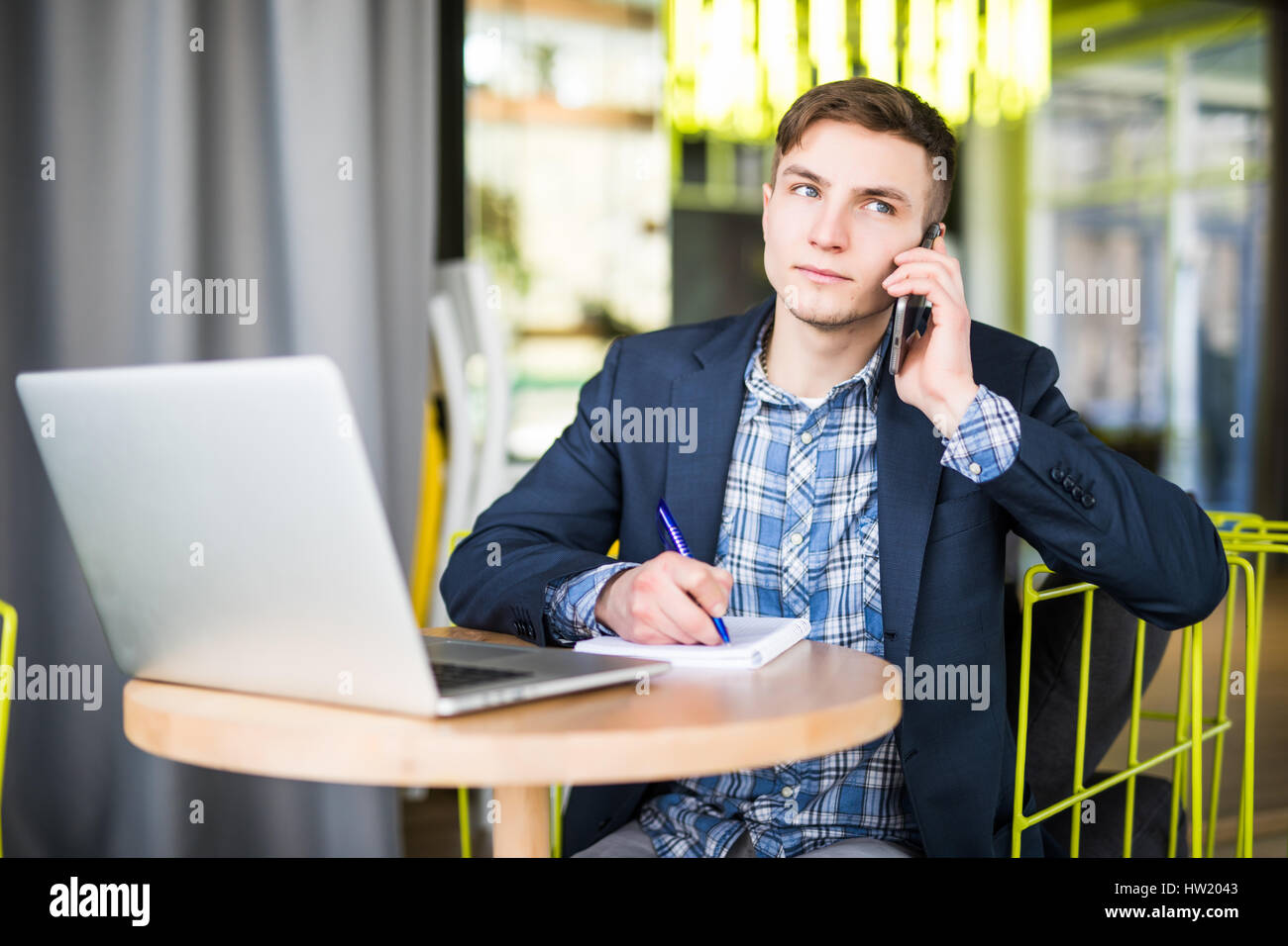 Man on the phone and write in notebook in his office or cafe Stock ...