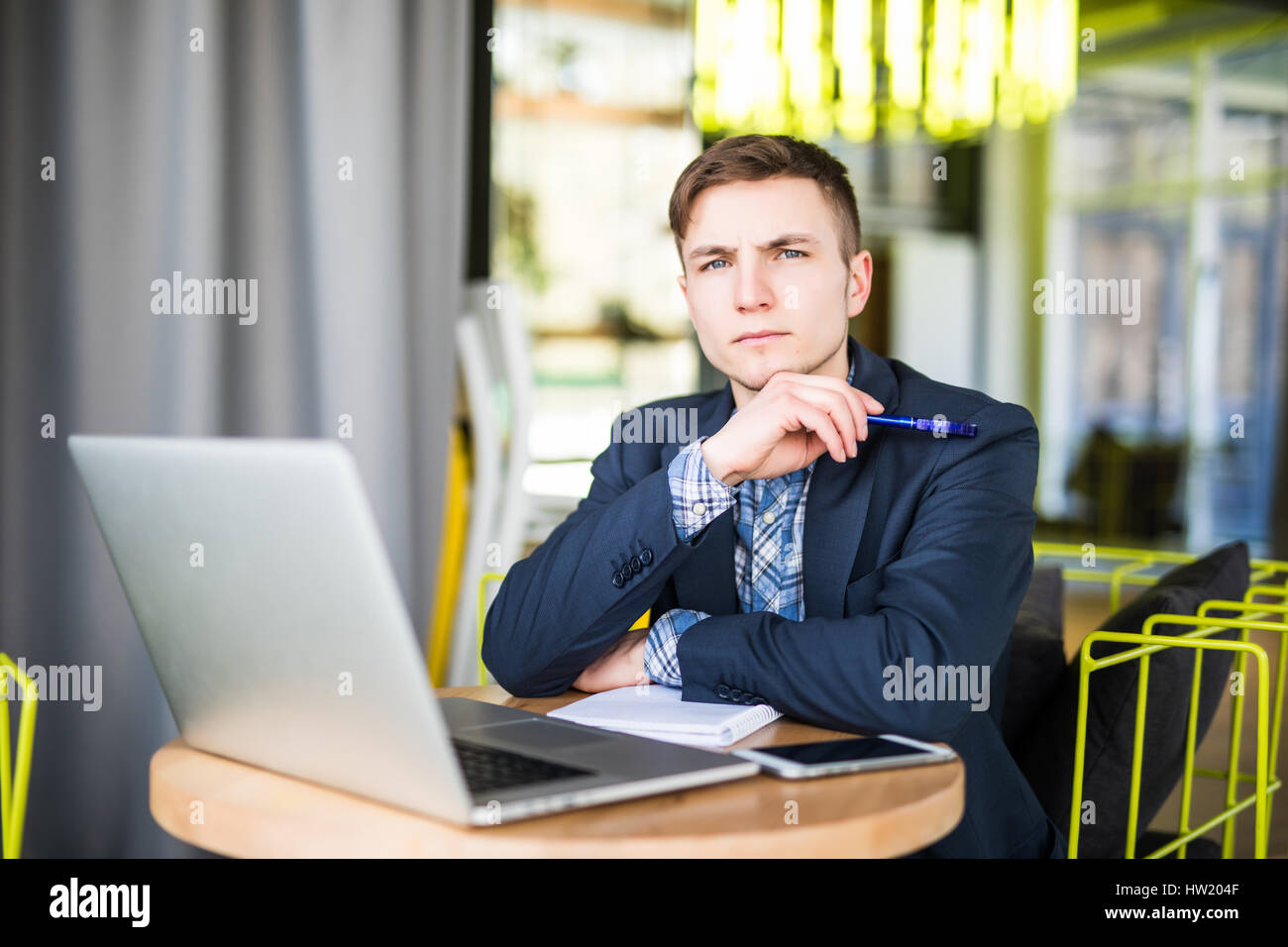 Tensed Young Man Working on Laptop at Cafe Table Stock Photo - Alamy