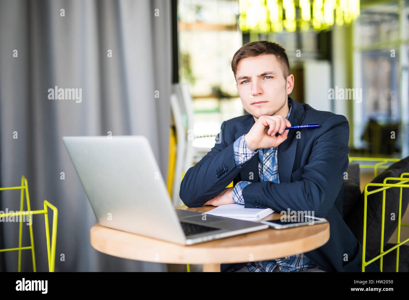 Tensed Young Man Working on Laptop at Cafe Table Stock Photo - Alamy