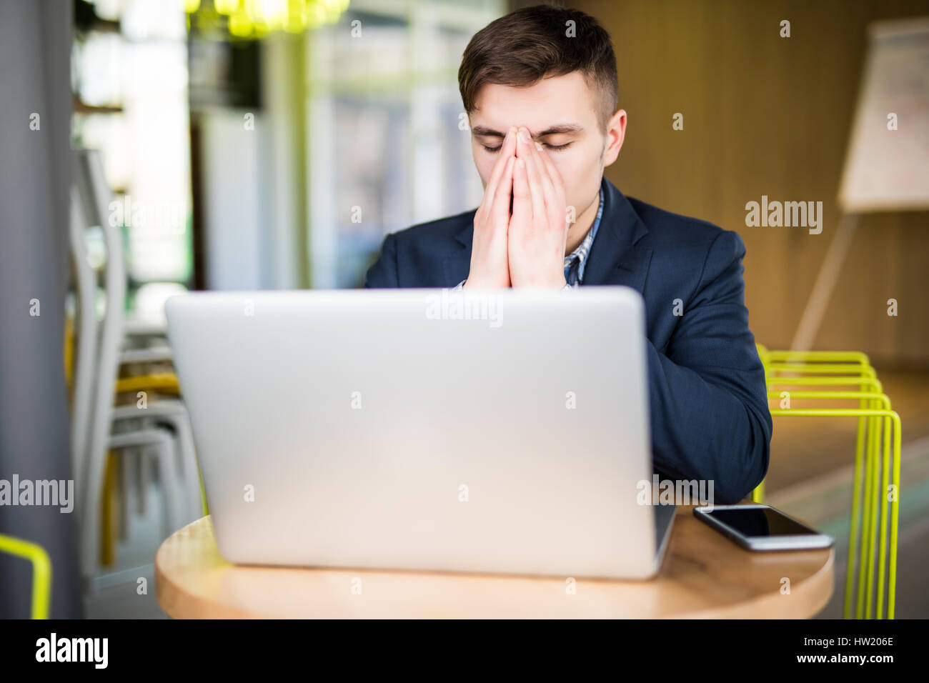 Feeling sick and tired. Frustrated young man massaging his nose and ...