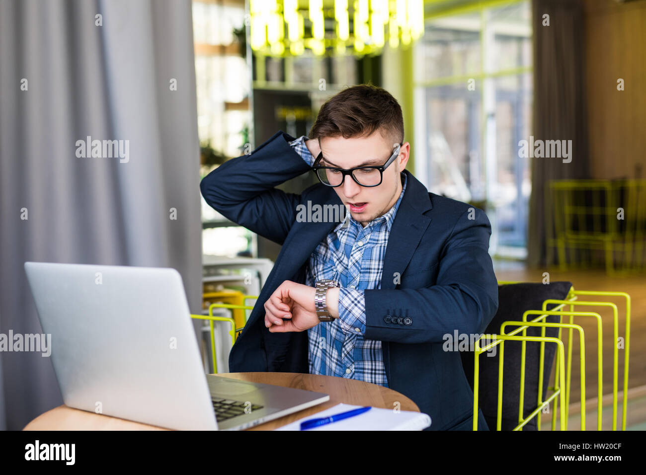 Worried businessman running out of time watching the clock at office ...