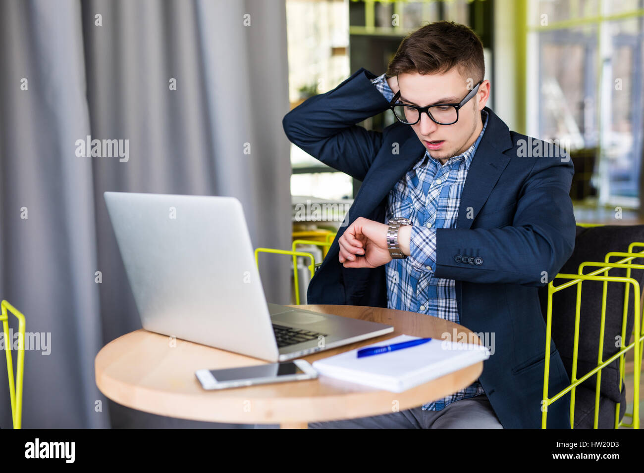 Worried businessman running out of time watching the clock at office ...