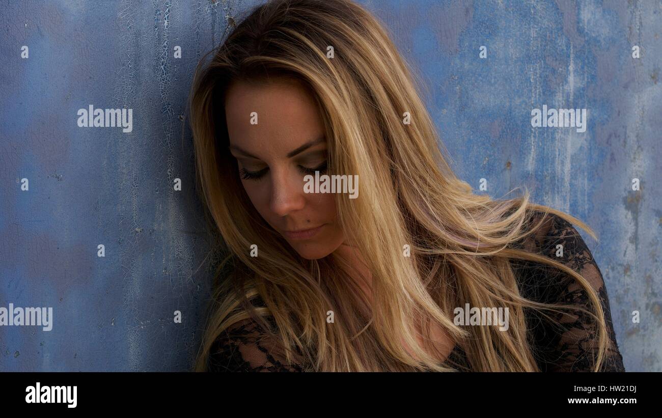Beautiful blonde woman looking down Stock Photo - Alamy