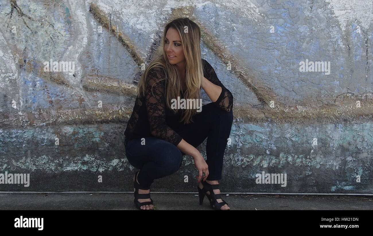Beautiful blonde woman looking down Stock Photo - Alamy