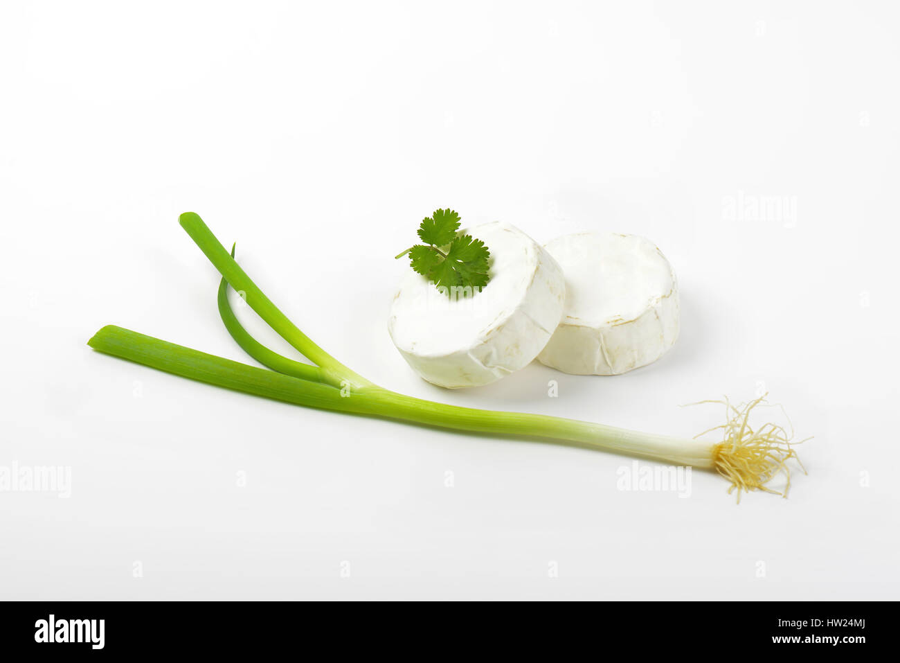 Wheels of soft white cheese and spring onion Stock Photo - Alamy