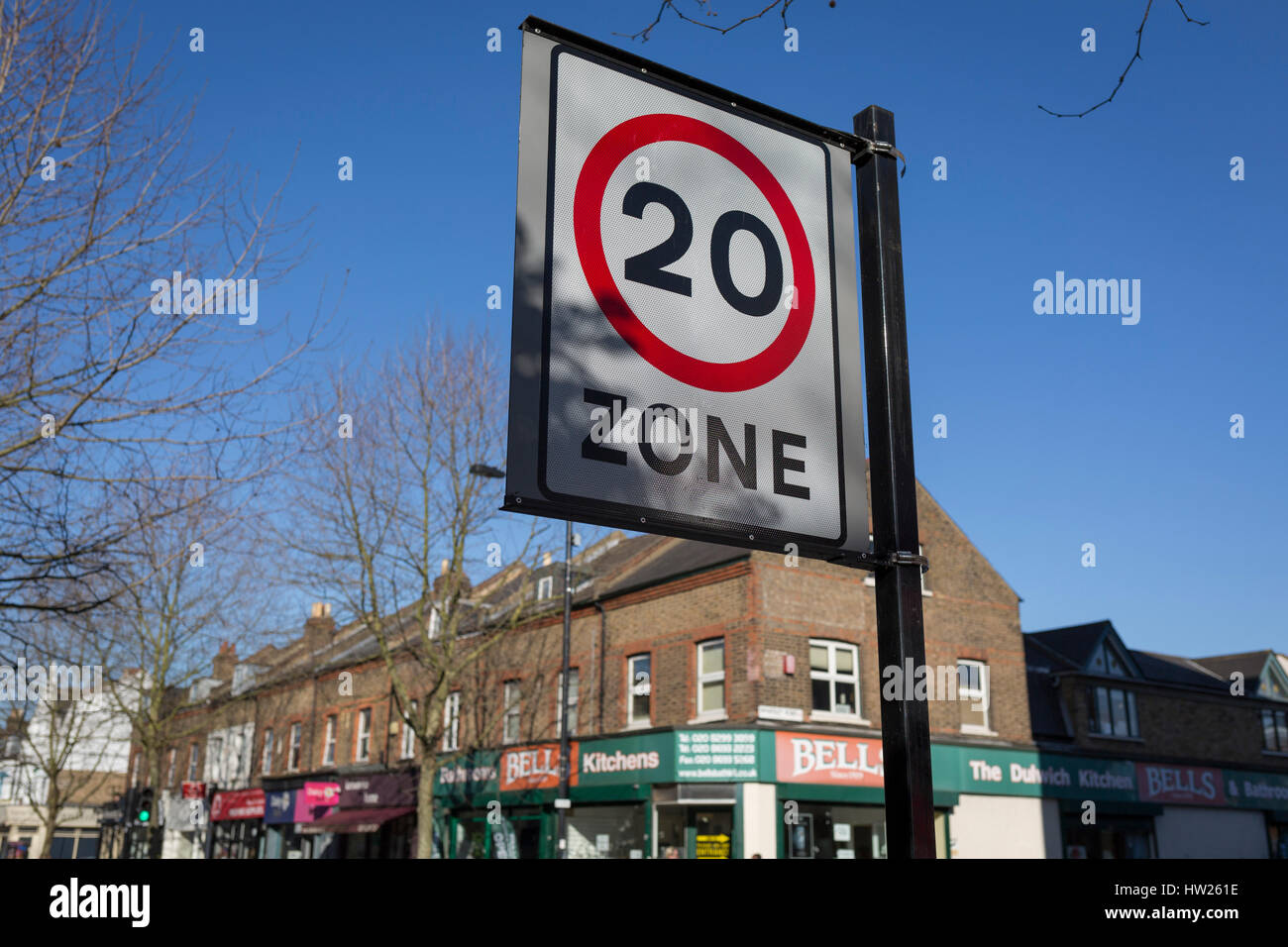 A 20mph speed limit signpost and local shops on Lordship Lane, in East ...