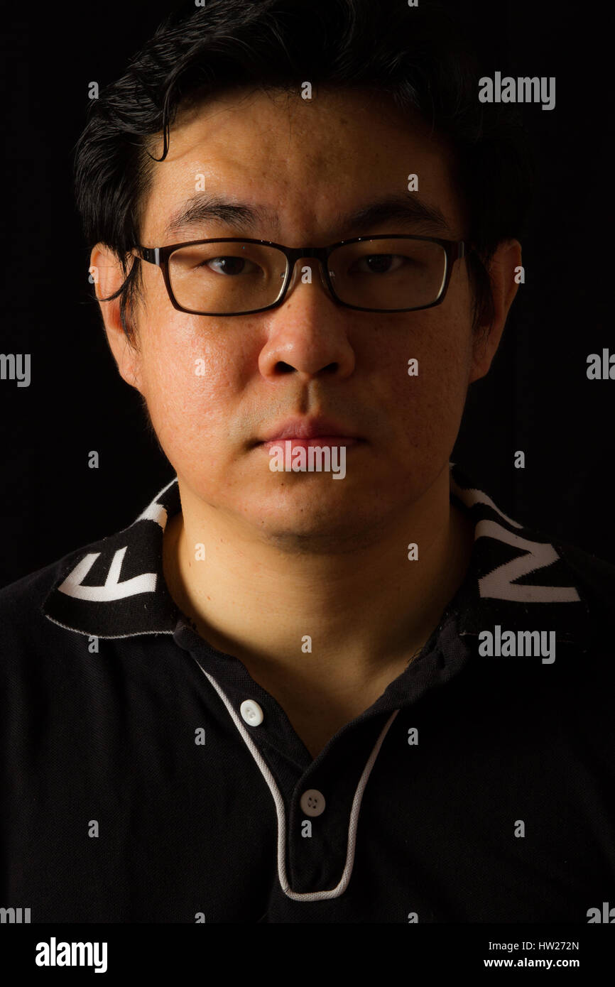 Asian Chinese Guy Portrait in dark background studio shots Stock Photo ...