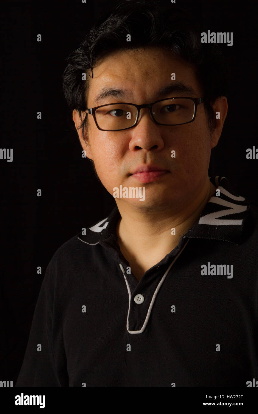 Asian Chinese Guy Portrait in dark background studio shots Stock Photo ...