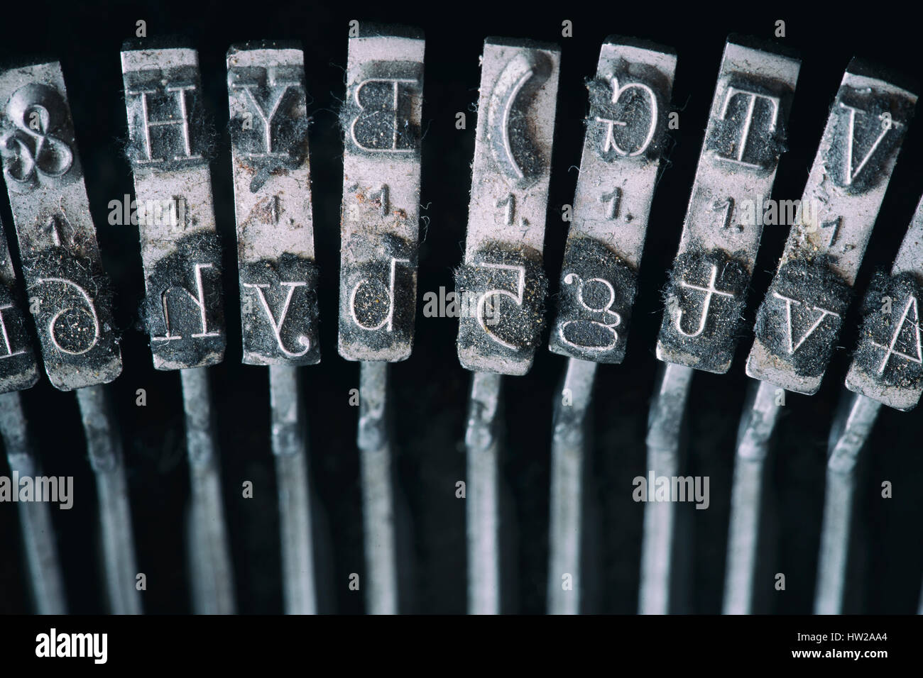 Close up shot of metal pieces with letters in typing machine mechanism ...