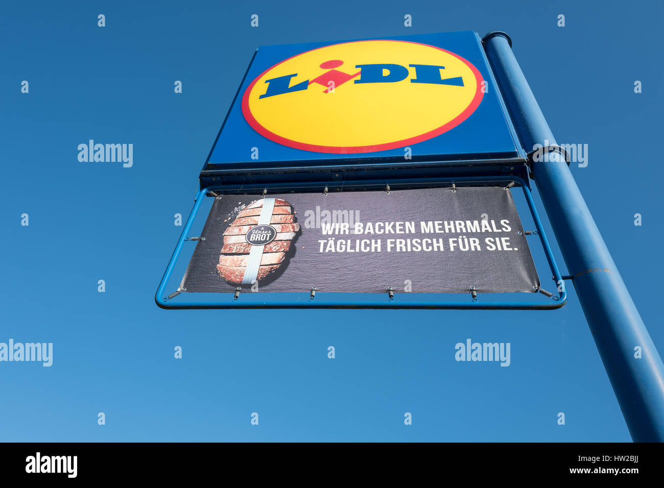 Lidl sign (with inhouse bakery) against blue sky. Lidl is the largest ...