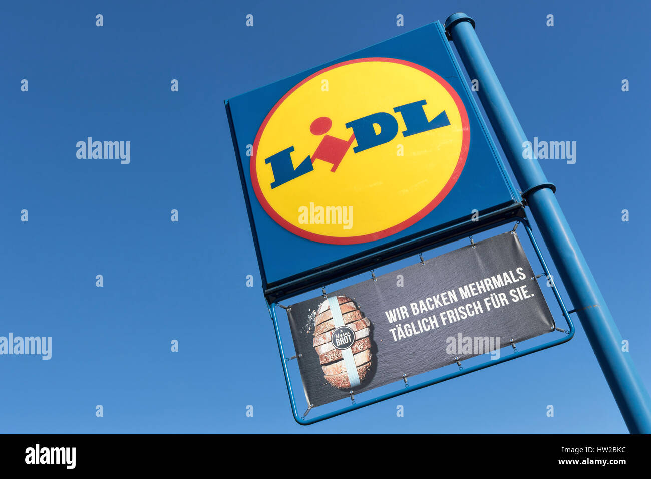 Lidl sign (with inhouse bakery) against blue sky. Lidl is the largest ...