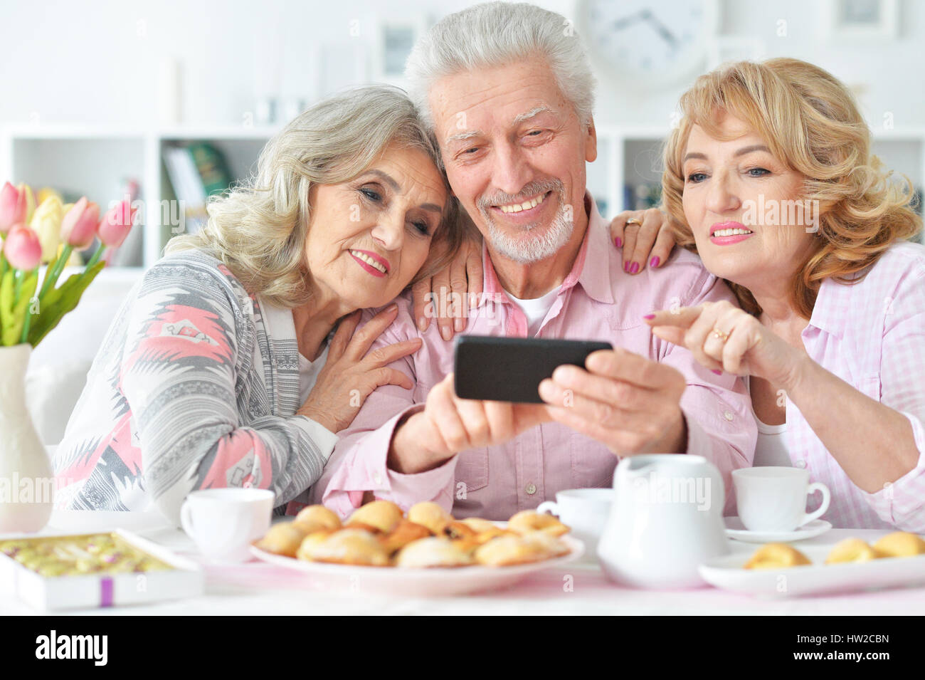 Elderly people having breakfast and using mobile phone Stock Photo - Alamy