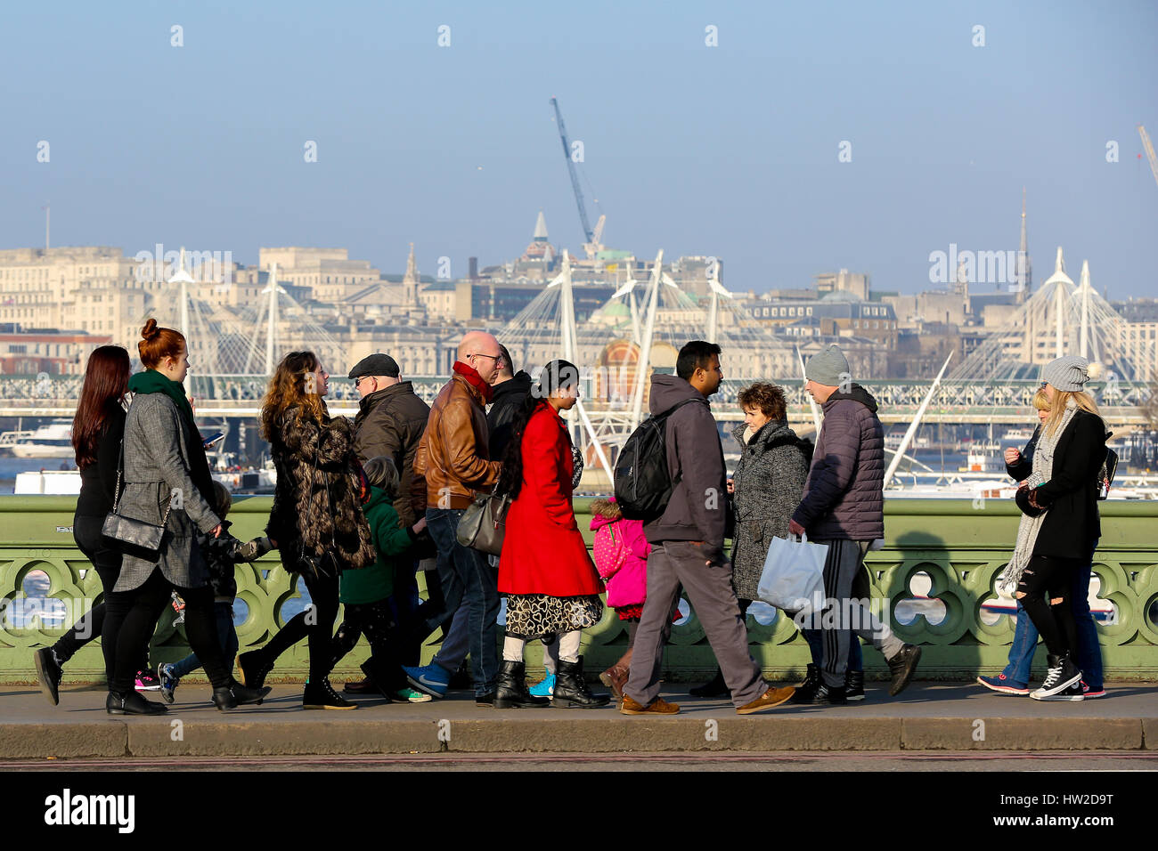 Tourists out and about on a sunny but cold and windy day in Westminster ...