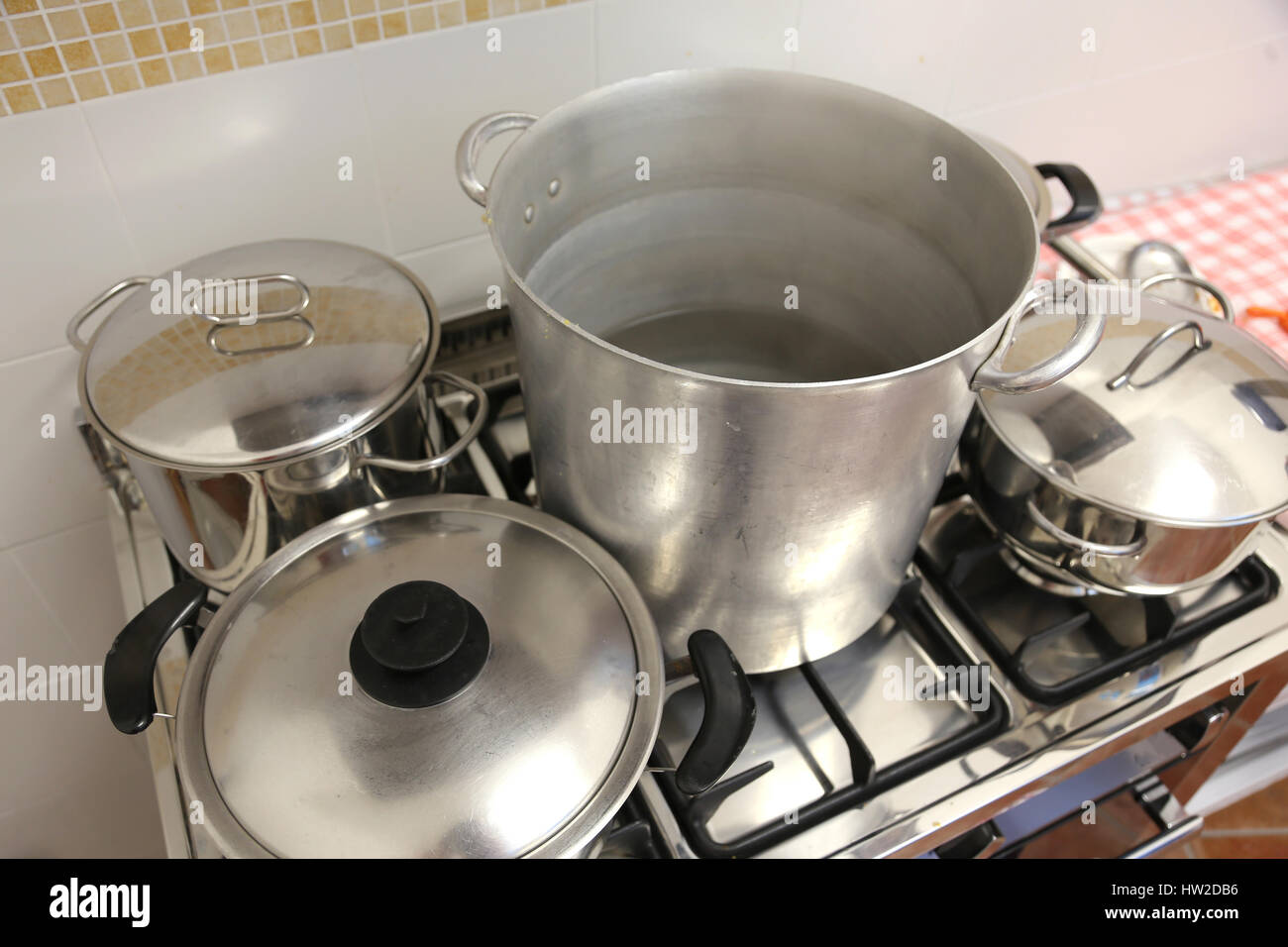 many large pots with steel lid on the stove of the large industrial ...