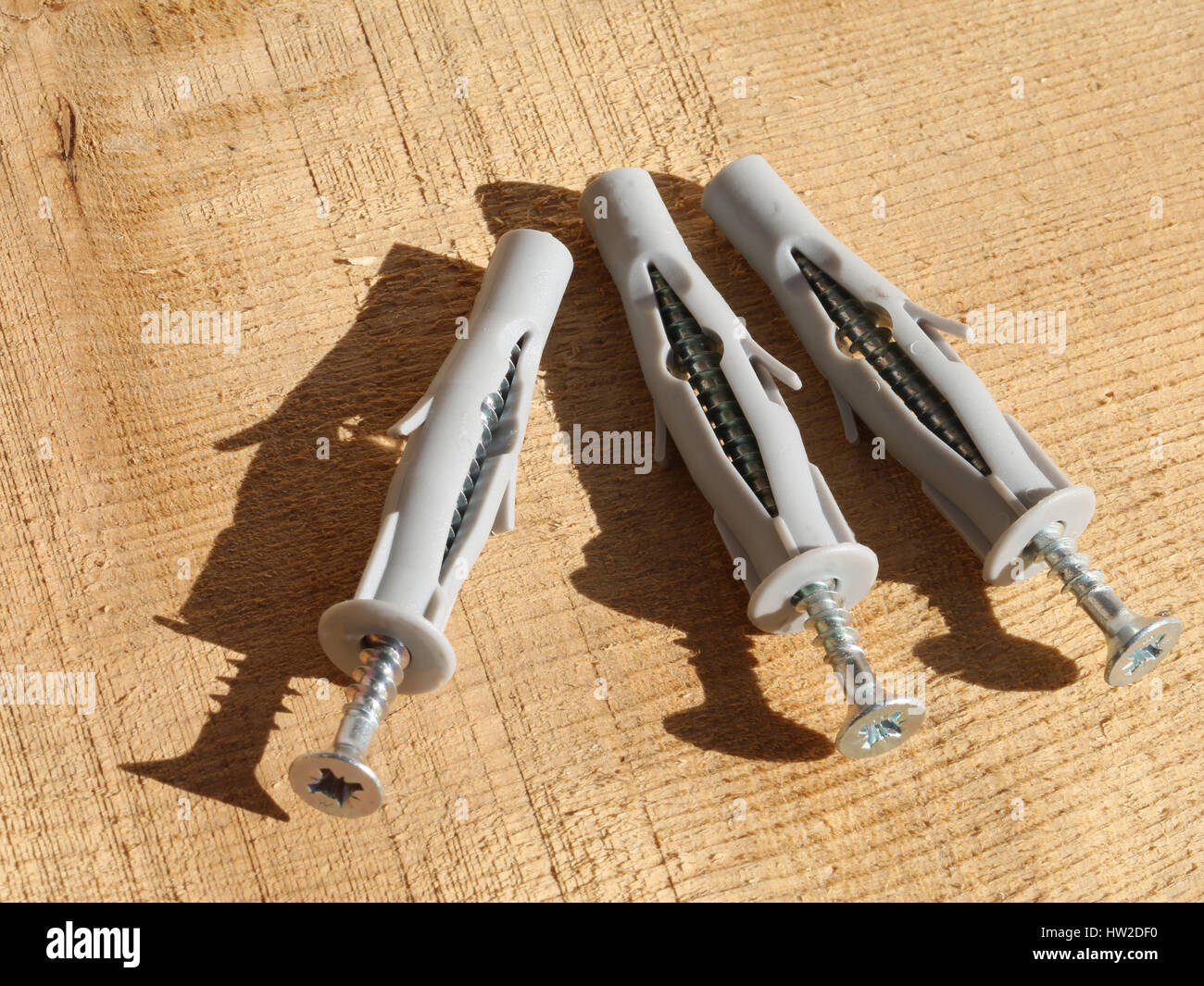 three anchors to secure the materials on the wall and rough wooden ...