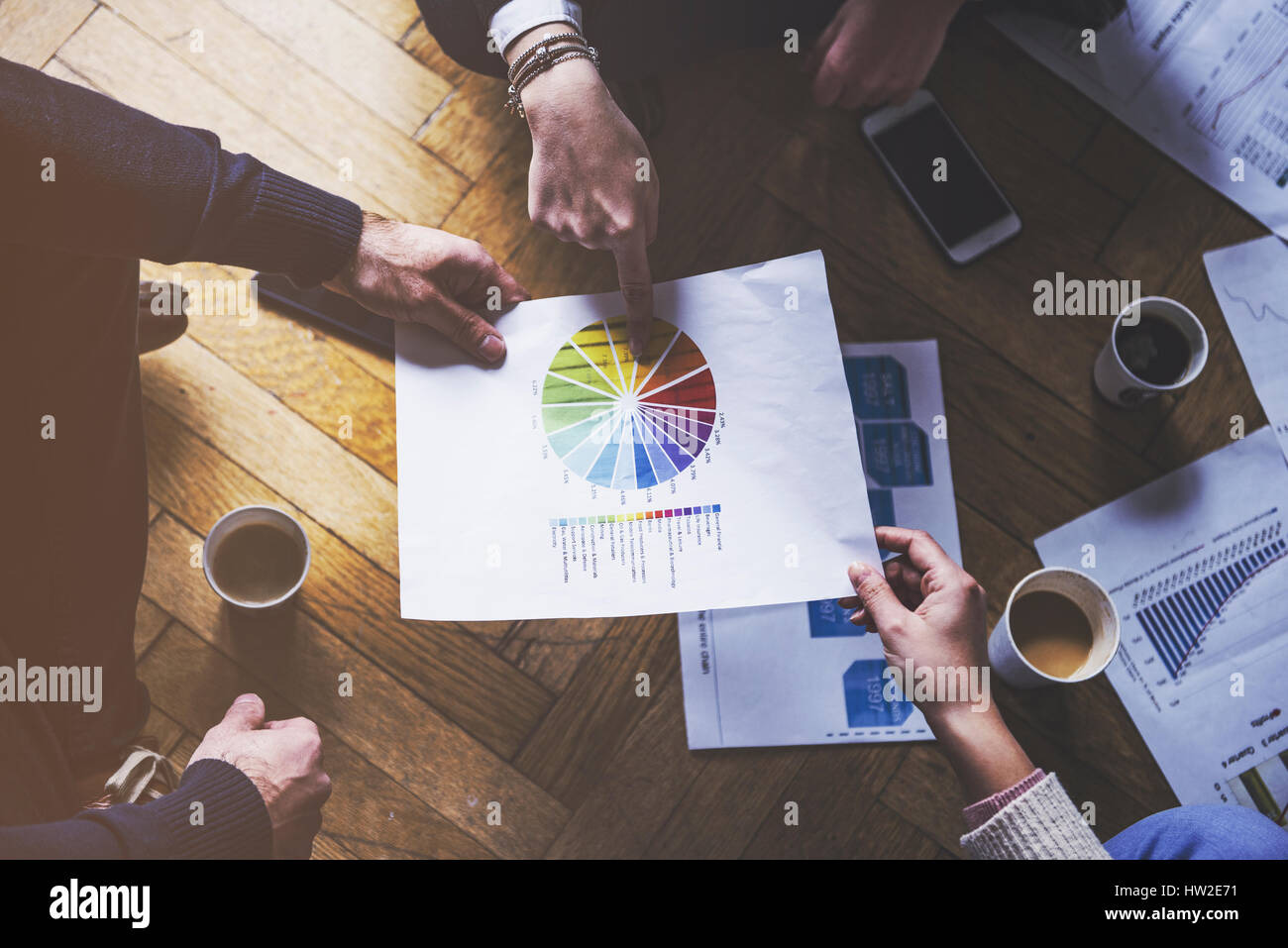 Small team working together with business reports Stock Photo - Alamy