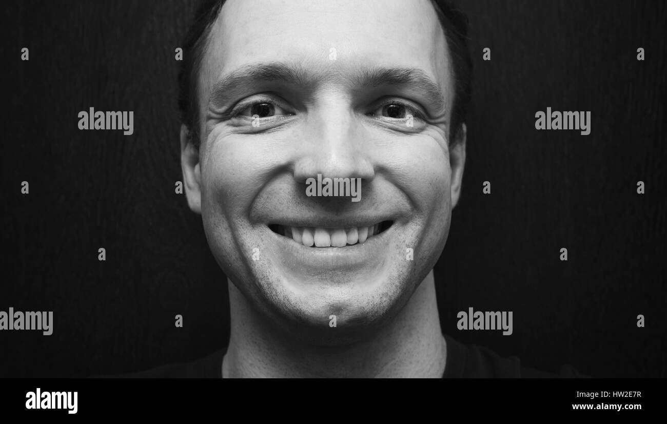 Young handsome smiling Caucasian man. Close-up studio face portrait ...