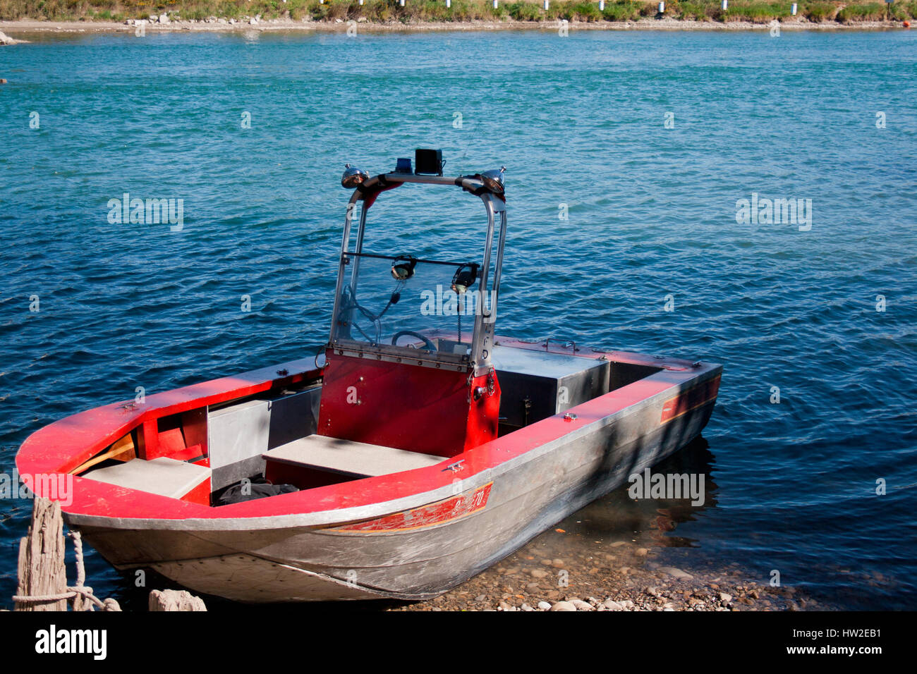 Weathered metal boat with red paint in water Stock Photo - Alamy