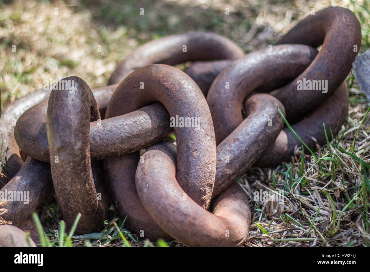 big rusty chain laying on floor Stock Photo - Alamy