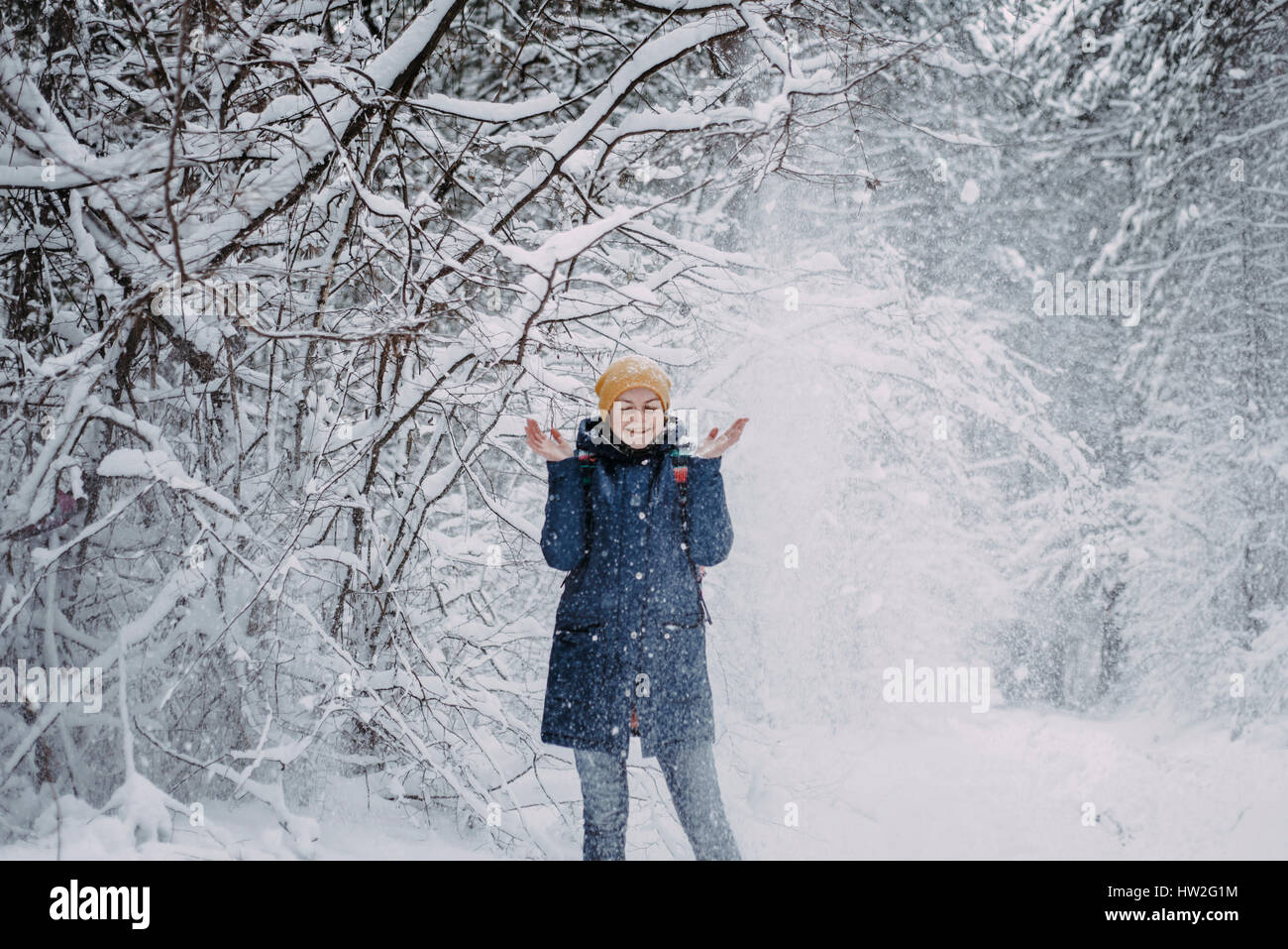 Snow falling on Caucasian woman in forest Stock Photo - Alamy