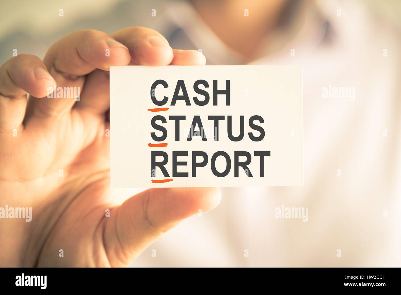 Closeup on businessman holding card with CSR CASH STATUS REPORT acronym ...