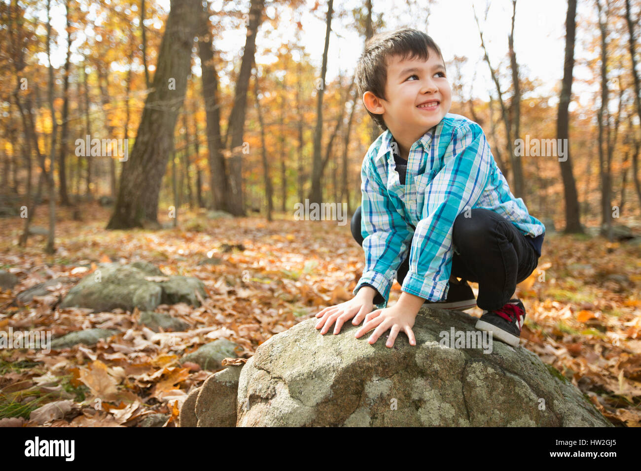 Child crouching on rock hi-res stock photography and images - Alamy