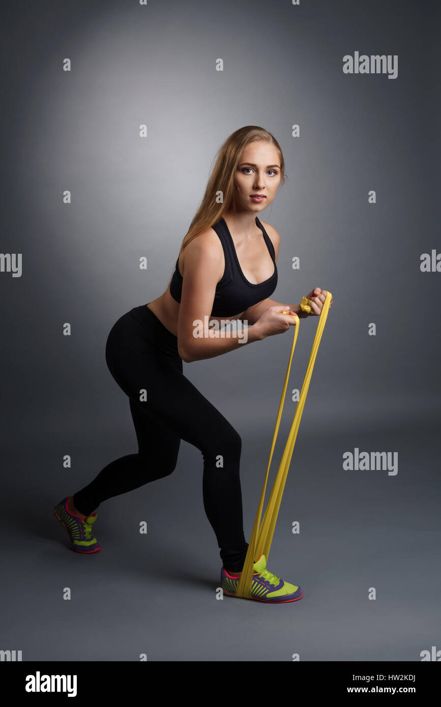 Pretty blonde fitness trainer exercising in studio Stock Photo - Alamy