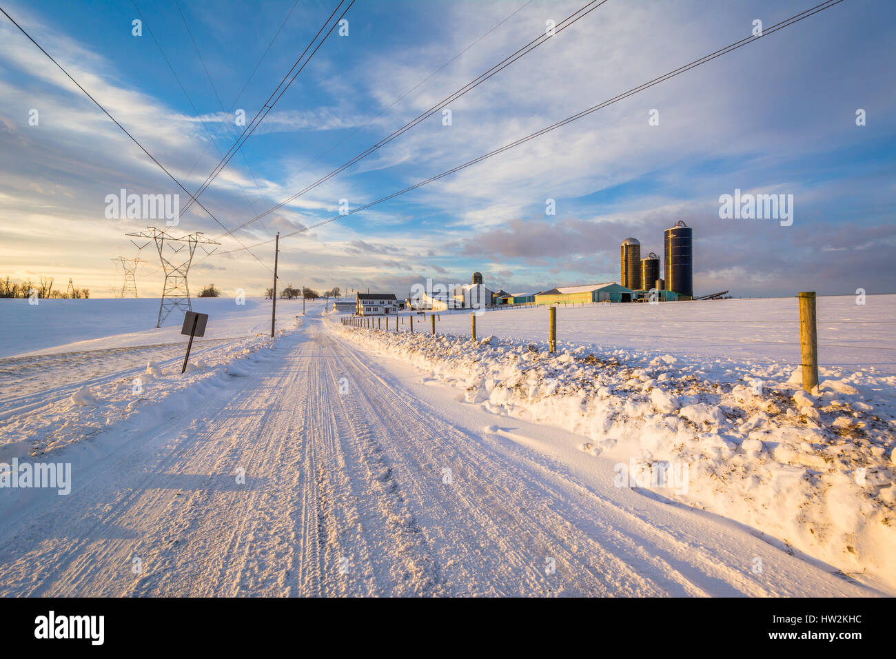 Snow covered road and a farm in a rural area of York County ...
