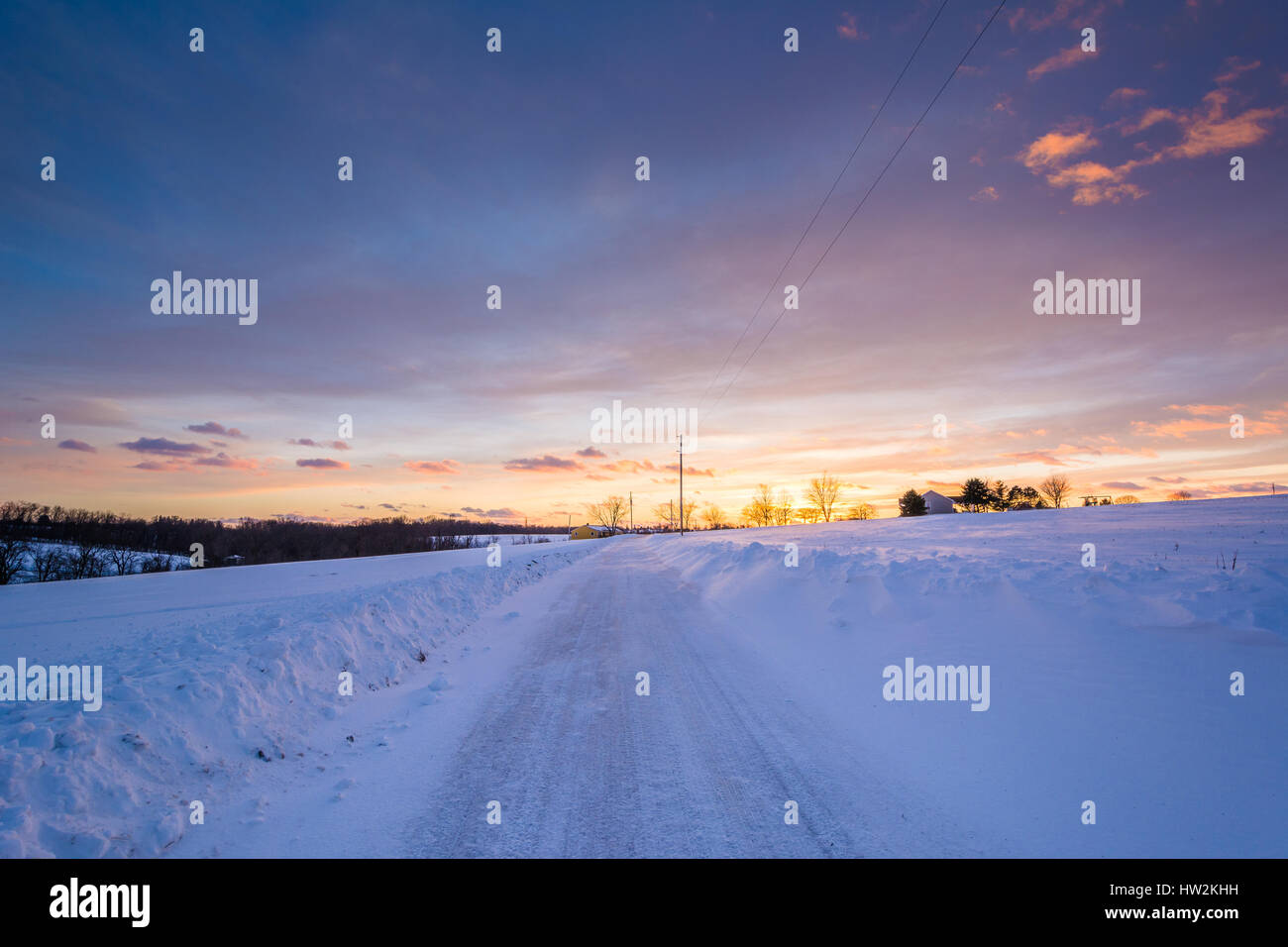 Sunset over a snow covered road in a rural area of York County ...