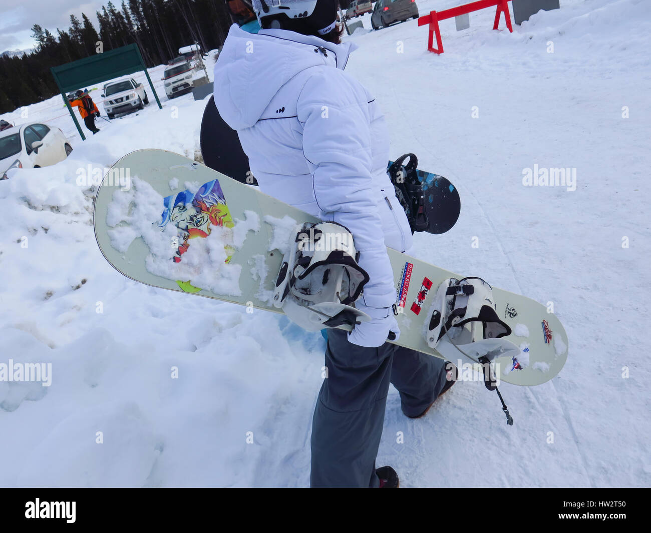 Young woman walking with snowboard Stock Photo - Alamy