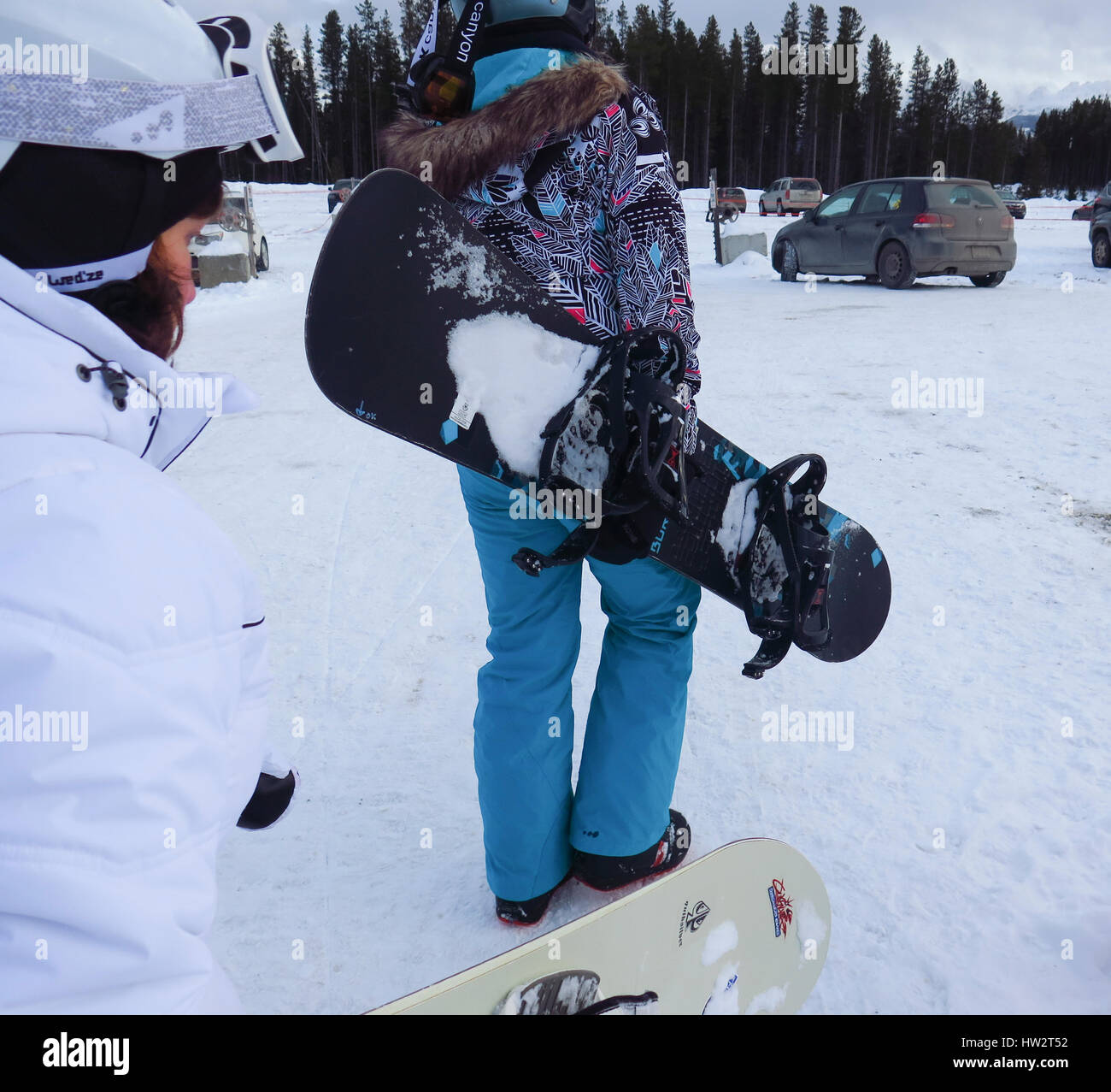 Young woman walking with snowboard Stock Photo - Alamy