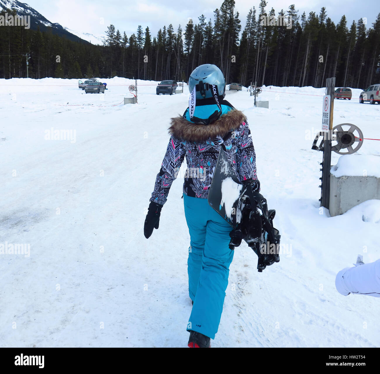 Young woman walking with snowboard Stock Photo - Alamy
