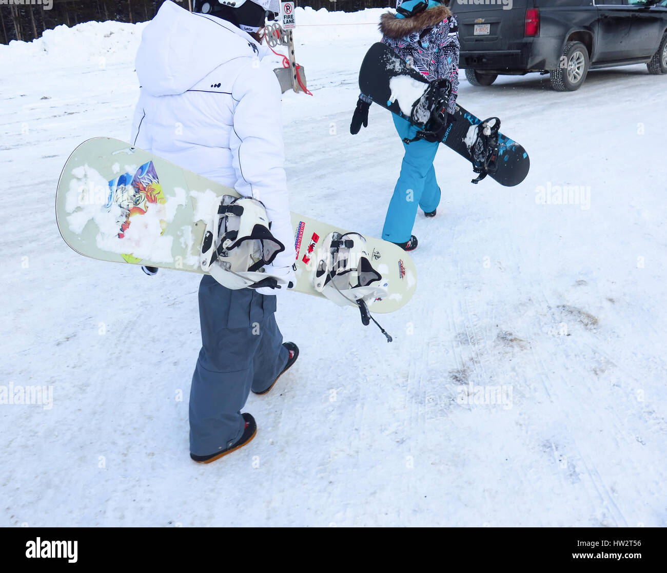 Young woman walking with snowboard Stock Photo - Alamy