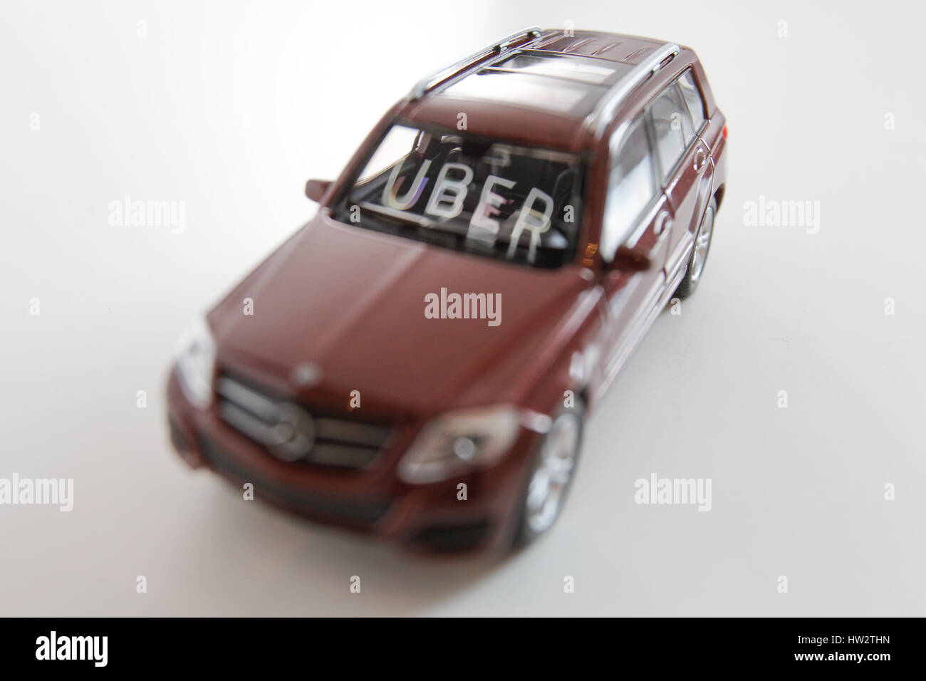 A model Mercedes vehicle is seen with the Uber logo reflected in its ...