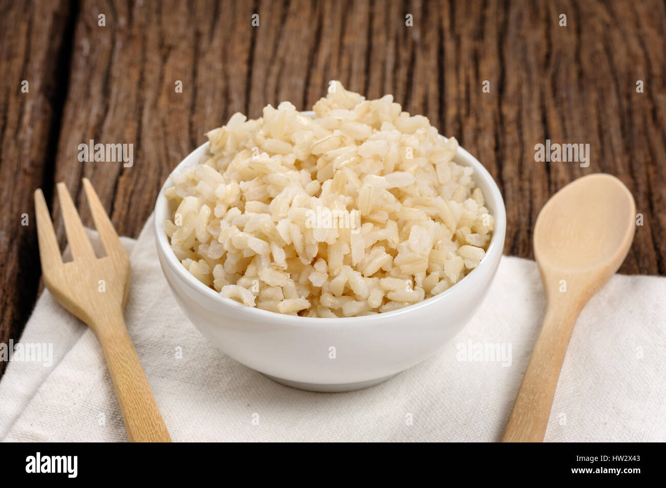 cooked brown rice in white bowl, healthy eating Stock Photo - Alamy