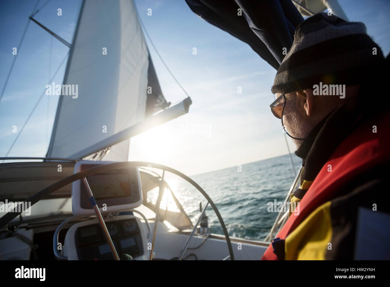 Side view of mature man standing at helm of yacht in sea Stock Photo ...