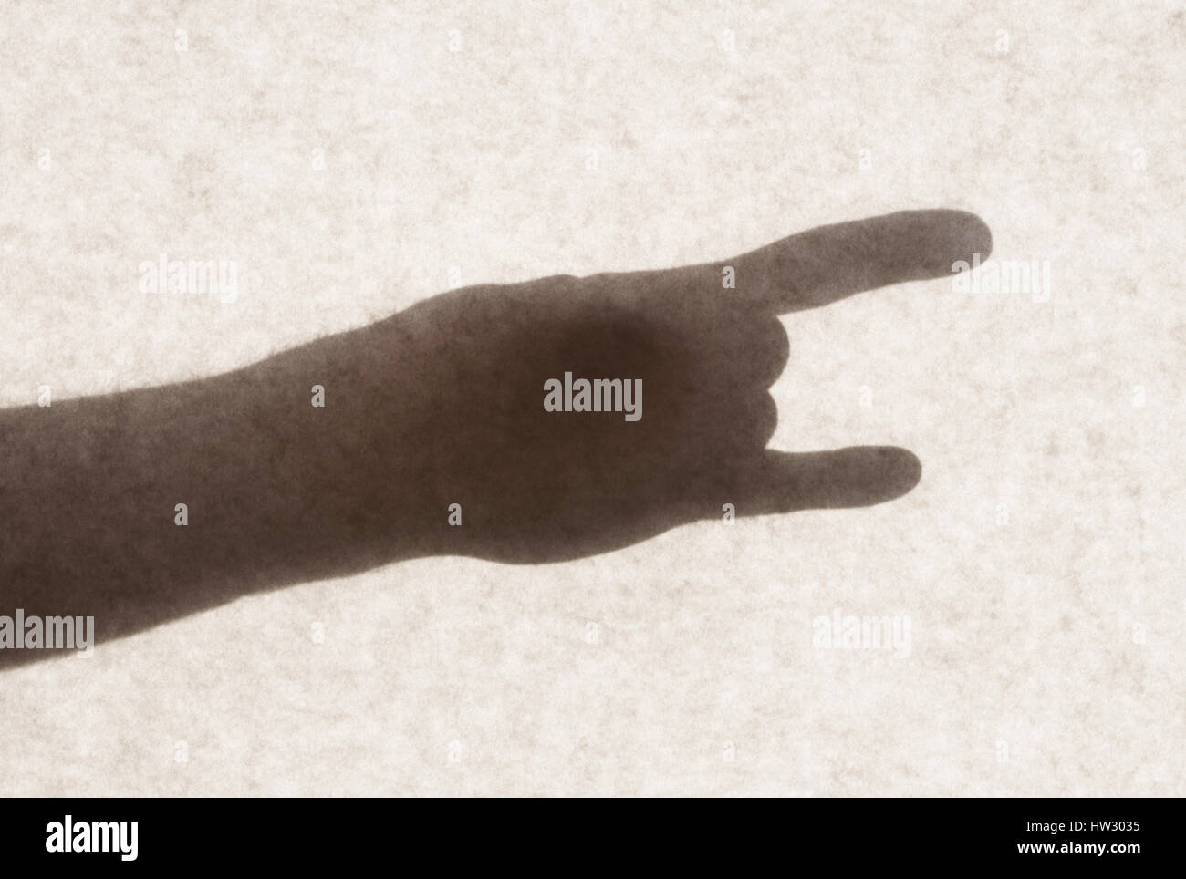 Silhouette behind a transparent paper - Rock symbol Stock Photo - Alamy