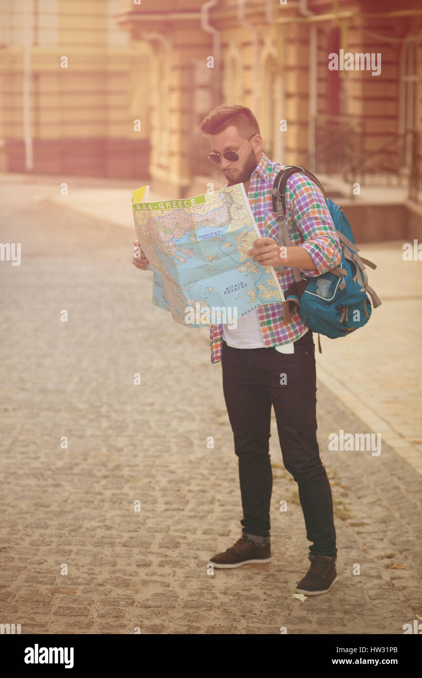 Young man looking at map hi-res stock photography and images - Alamy