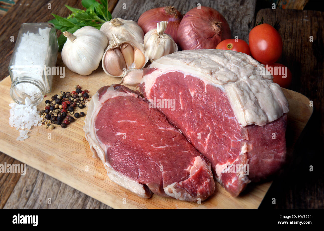 Rare Angus beef cut and ready for cooking display with seasoning and ...