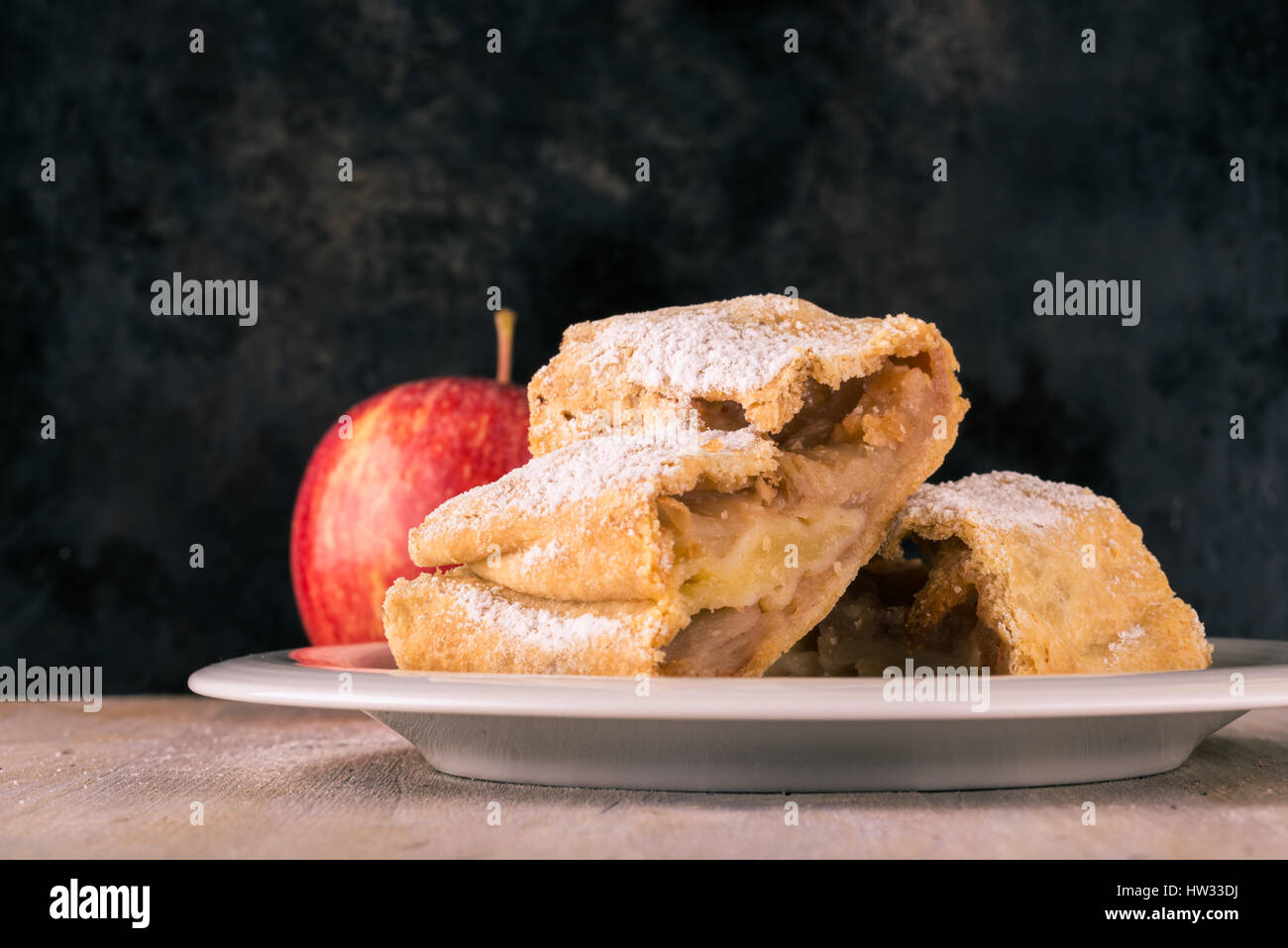 Horizontal photo with traditional apple strudel with fruit and powder ...