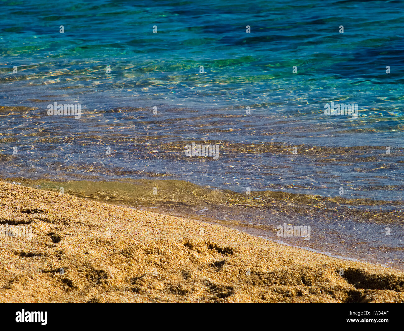The clean sea water and sandy beach Stock Photo - Alamy