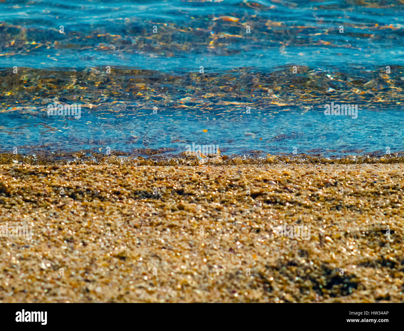 Sand, beach and the clean sea water Stock Photo - Alamy