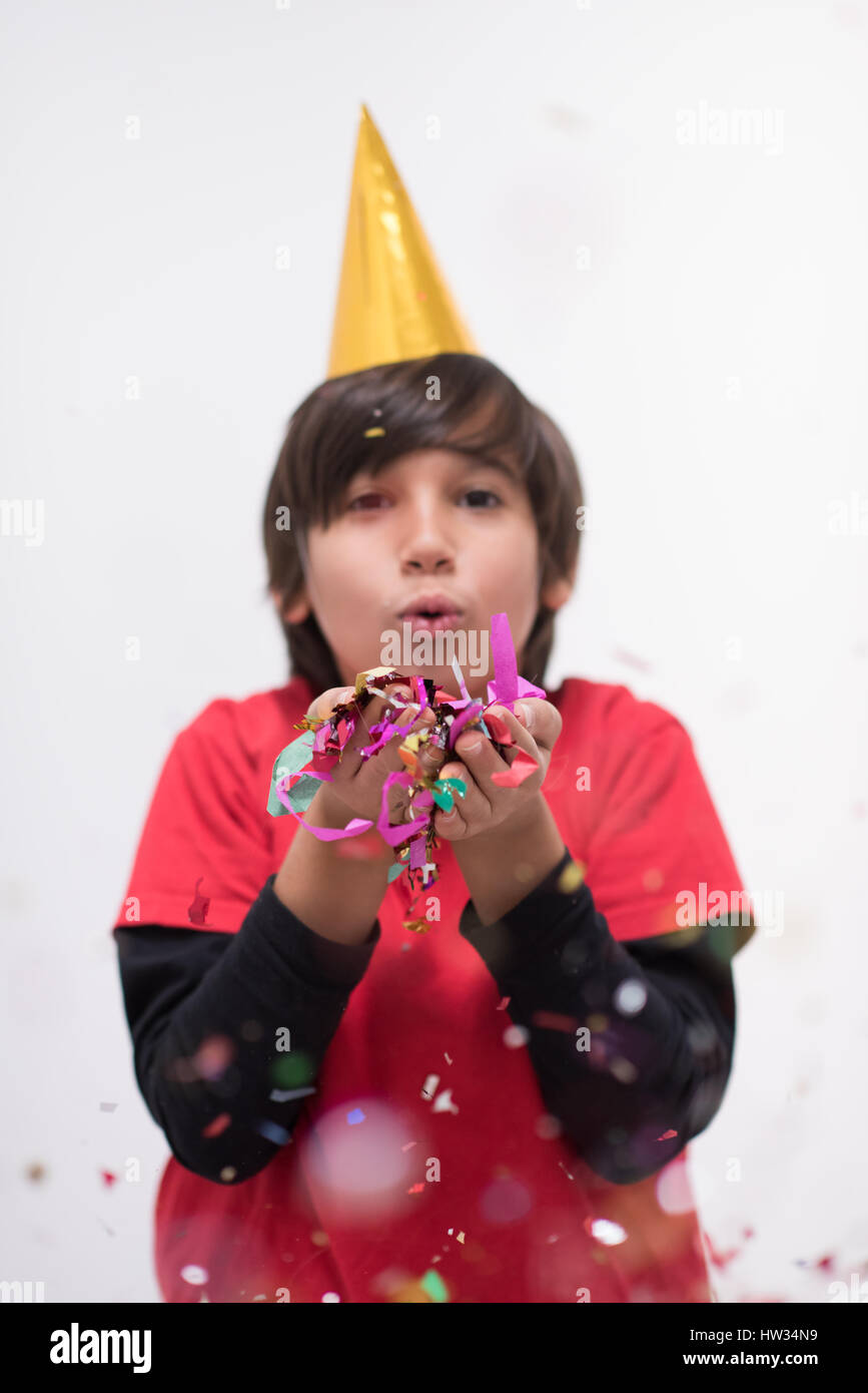 Happy kid celebrating party with blowing confetti Stock Photo - Alamy