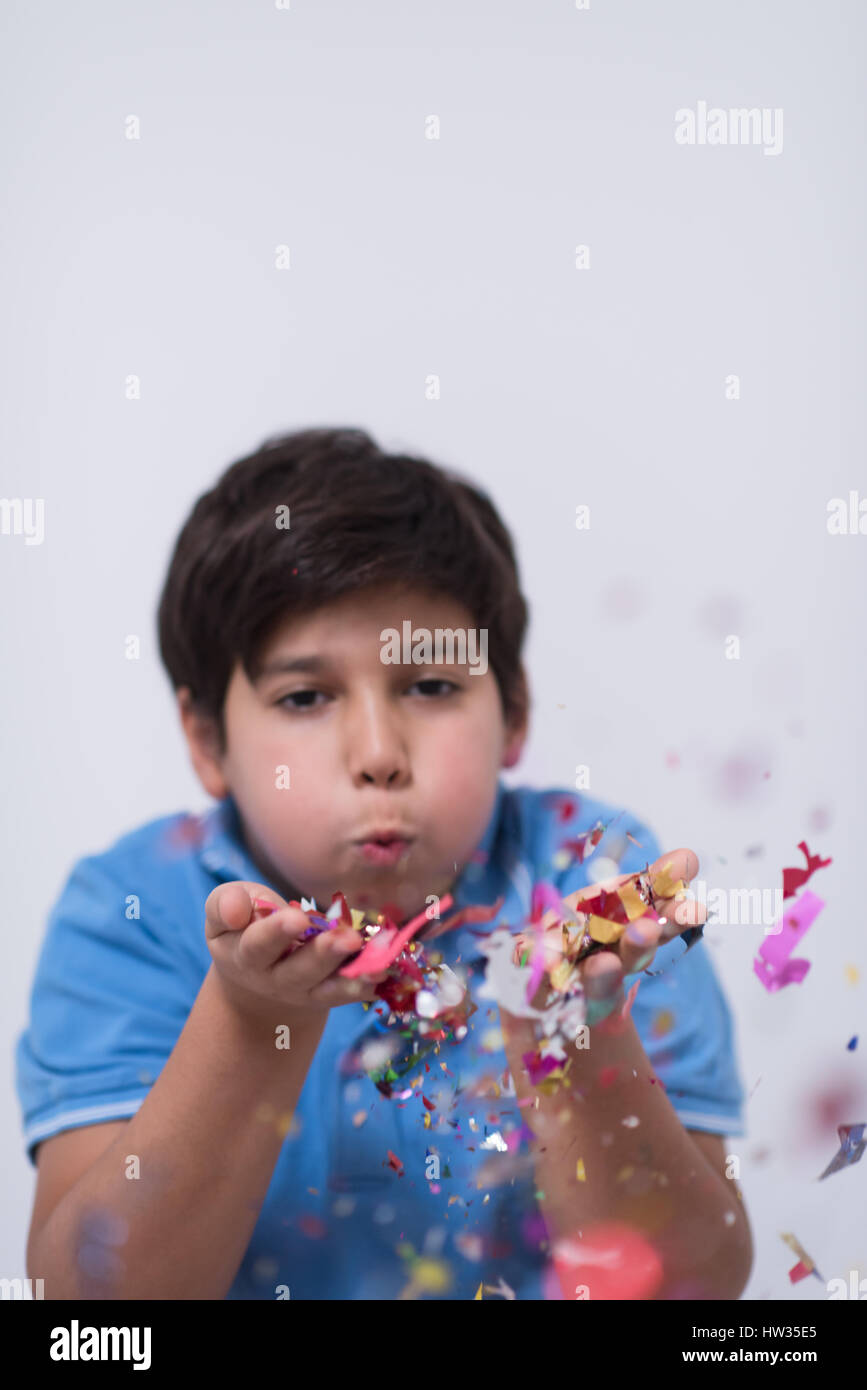 Happy kid celebrating party with blowing confetti Stock Photo - Alamy