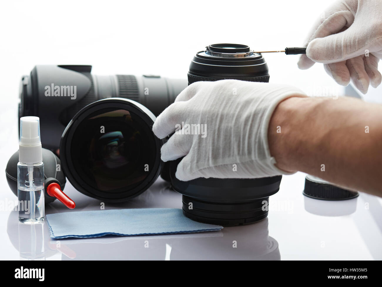Closeup of repairing photography lens isoalted on white background ...