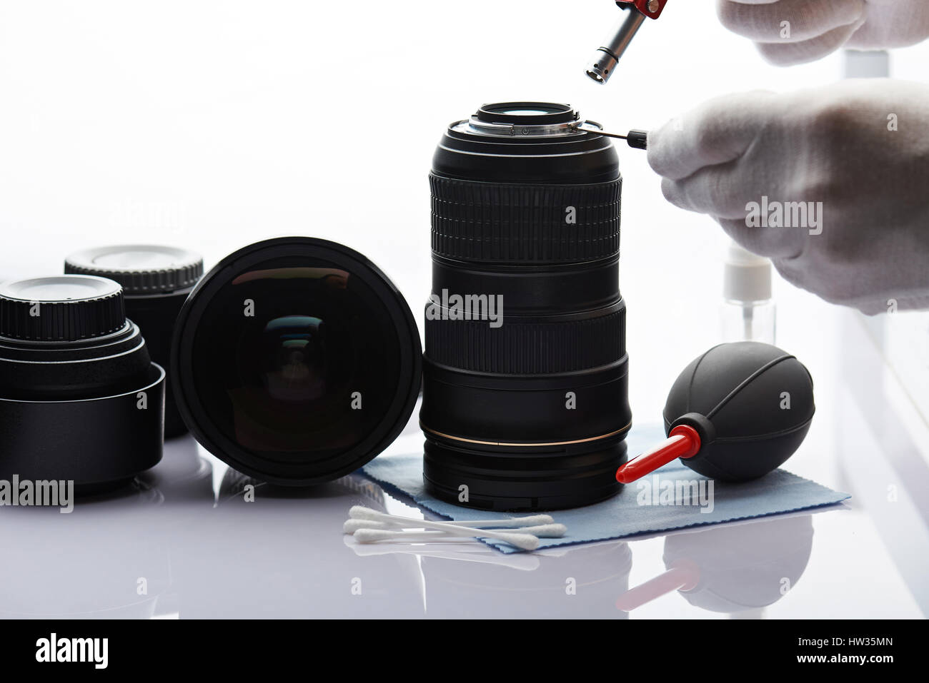 Closeup of fixing camera lens in white lab desk. Disassembling modern ...