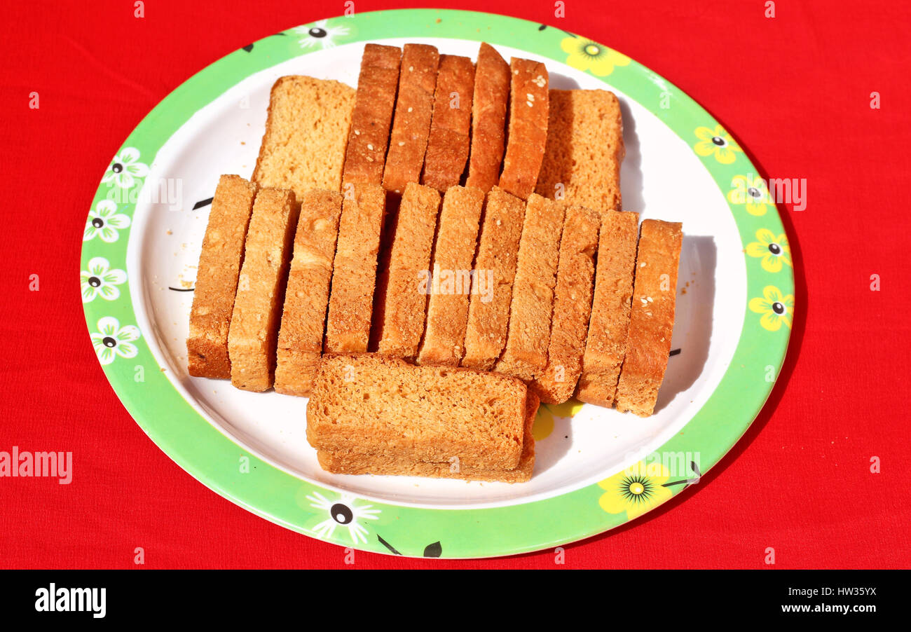 Toast put in white plate on red surface Stock Photo - Alamy