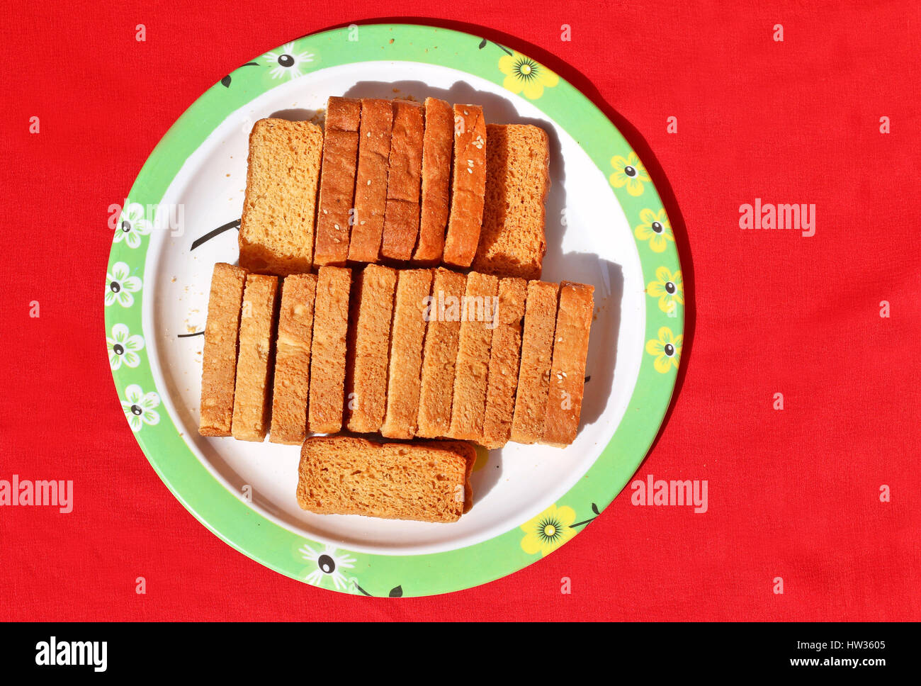 Toast put in white plate on red surface Stock Photo - Alamy