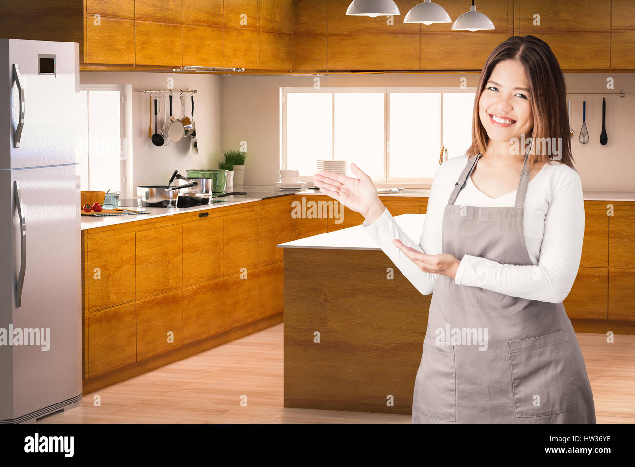 asian housekeeper with kitchen background Stock Photo - Alamy